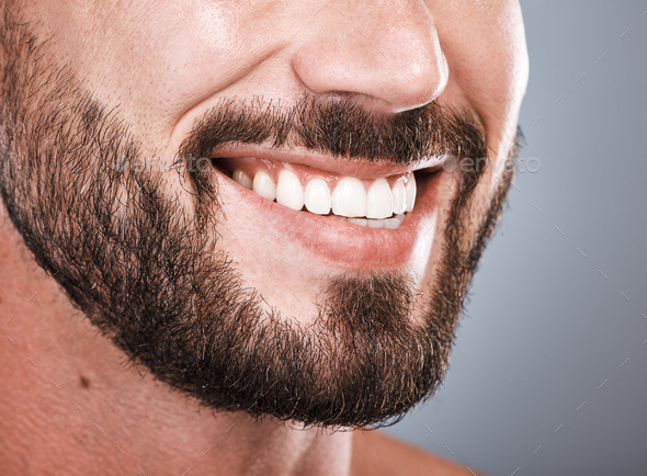 Smile, dental health and mouth of a man with teeth isolated on grey ...