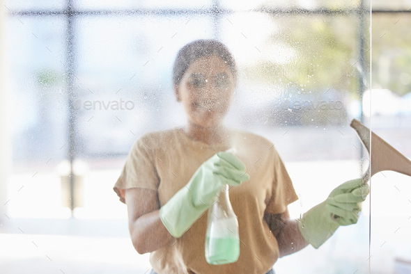 Happy, woman and cleaning window with smile, spray bottle and soap or ...