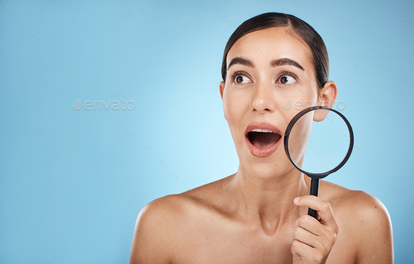 Woman, face and surprise with magnifying glass, beauty and acne with ...