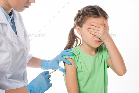 Pediatrician doing injection with vaccine to scared child isolated on ...