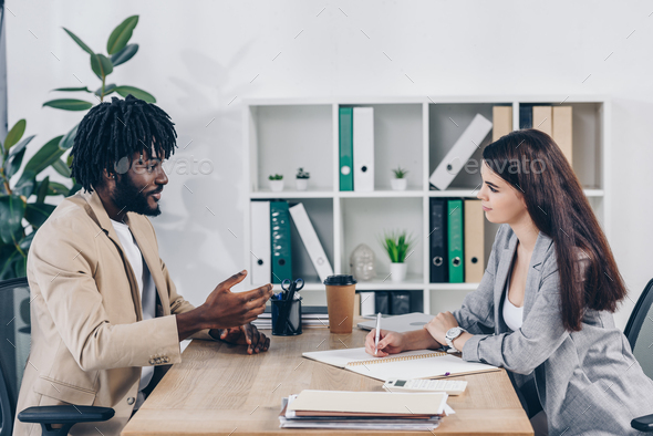 Recruiter and african american employee talking at job interview in ...