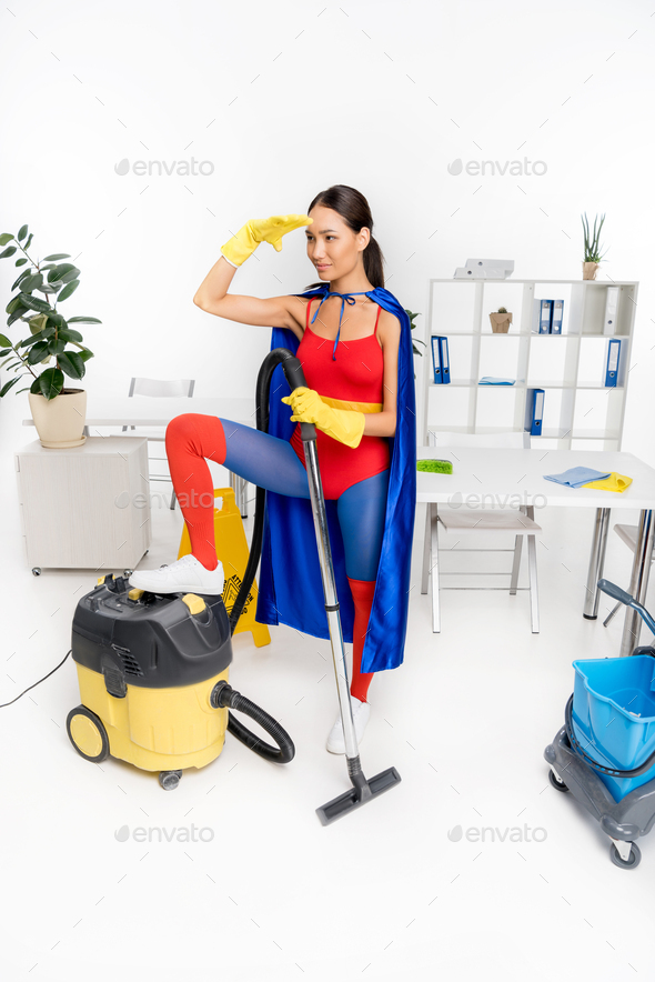 beautiful young asian woman in superhero costume posing with vacuum ...