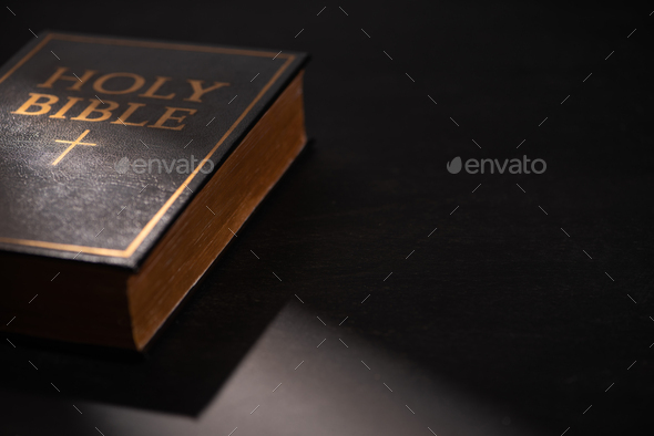 holy bible on black dark background with sunlight Stock Photo by ...