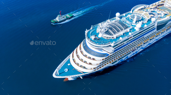 Aerial view of beautiful white cruise ship above luxury cruise running ...