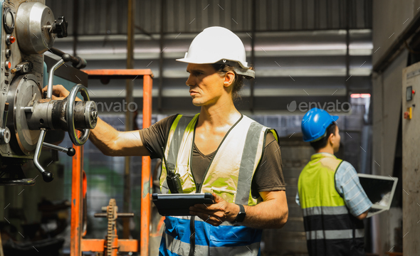 Mechanical engineer working in industry and factory wearing safety ...