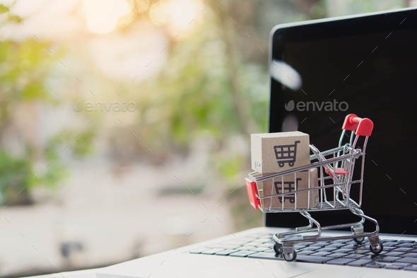 Shopping online. Cardboard box with a shopping cart logo in a trolley ...