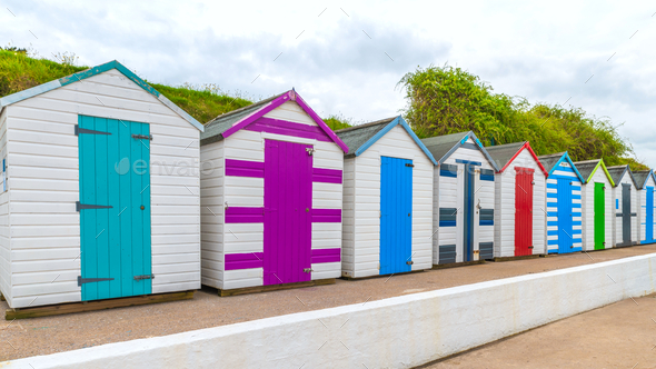 Colorful small beach houses. Multicolored beach sheds. Variety of ...