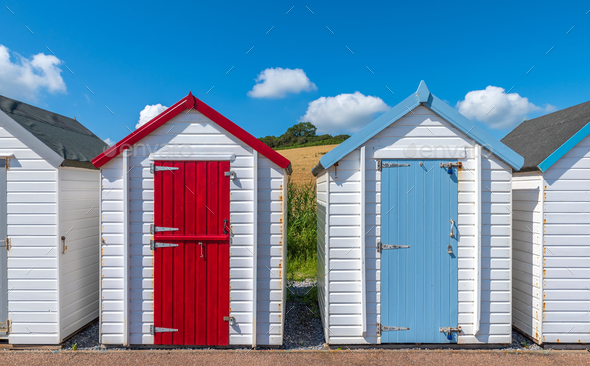 Colorful small beach houses. Multicolored beach sheds. Variety of ...