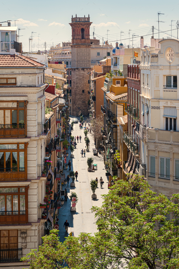View at Valencia downtown with people walking in the street. Rooftops ...