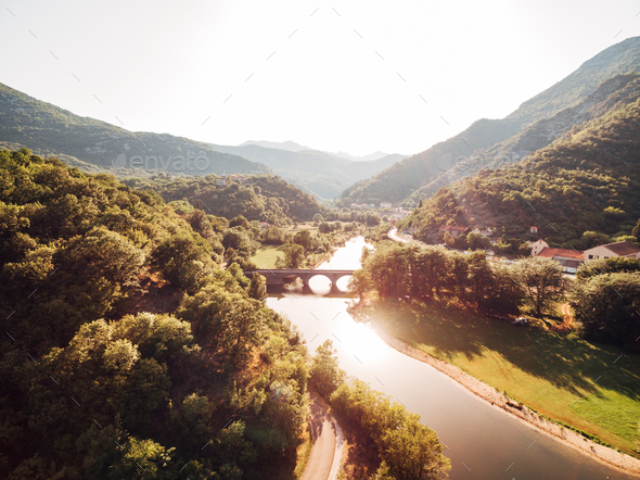Bridge over the Crnojevica river among green mountains. Montenegro Stock Photo by Nadtochii