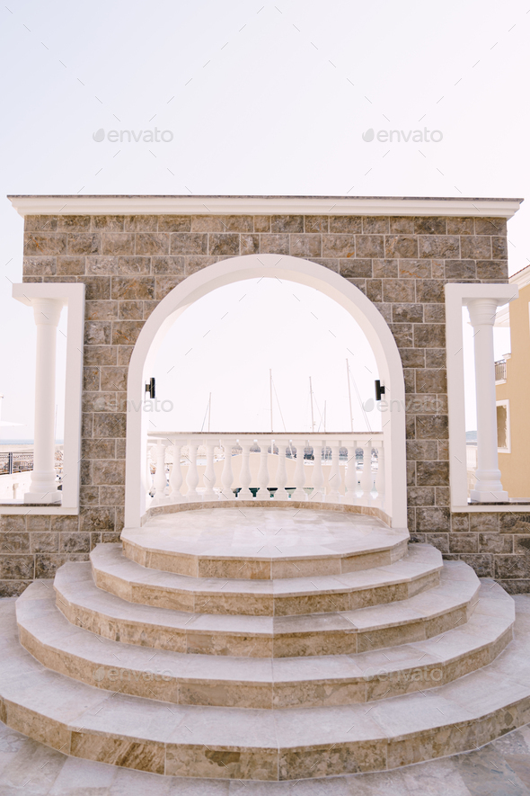 Arched balcony with balustrade and steps overlooking the Lustica bay ...