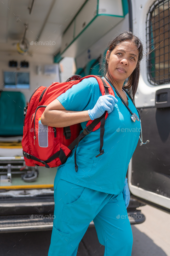 Vertical photo of a health technician in a hurry carrying a first-aid ...