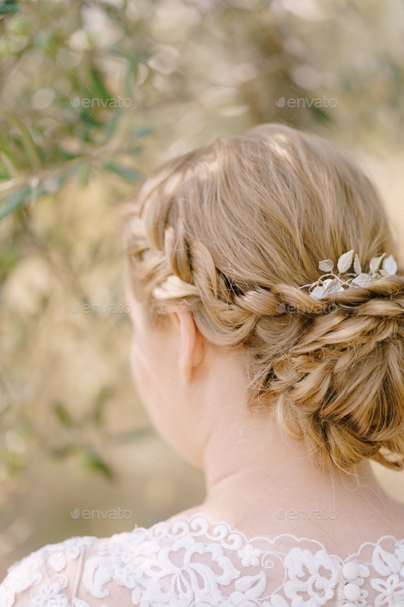 Bride hairstyle with braided braids. Back view Stock Photo by Nadtochii