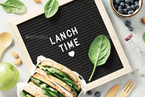 Lunch time letter board and healthy food flat lay Stock Photo by klenova
