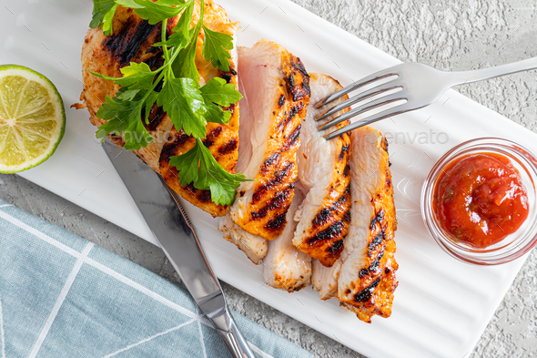 top view of slices of sliced grilled chicken fillet breast on a serving ...