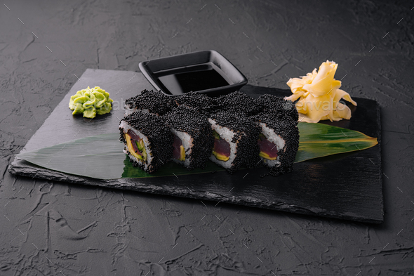 california rolls covered black tobiko on a black board Stock Photo by ...
