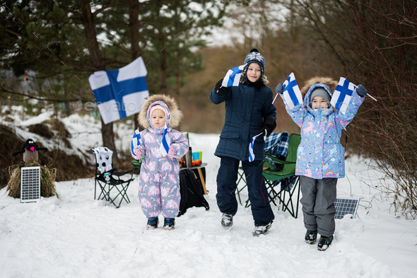 Three finnish children with Finland flags on a nice winter day. Nordic ...
