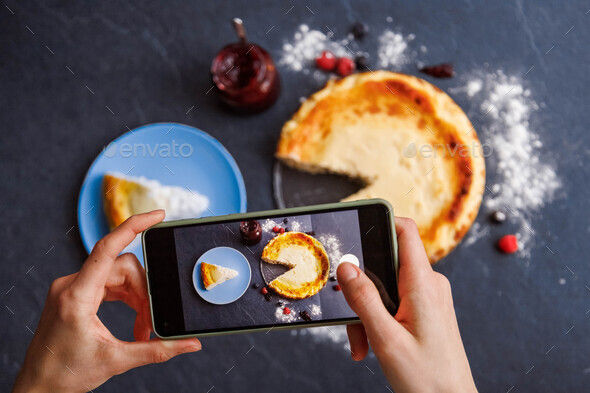 Woman hands taking a photo of a delicious cheesecake she is about to ...