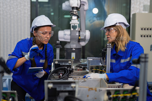 Female Electronics Factory Workers use tablet pc quality checking ...