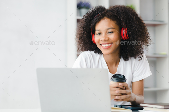 American woman in white room, she is a college student, she is studying ...