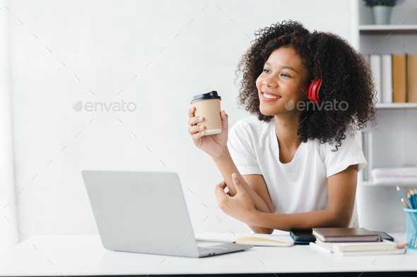 American woman in white room, she is a college student, she is studying ...