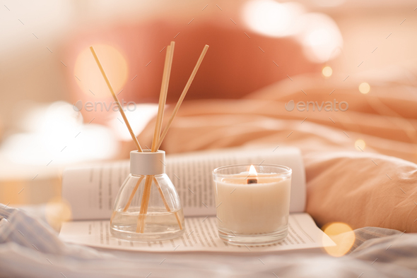 Home liquid diffuser with fragrance with candle and open book in ...