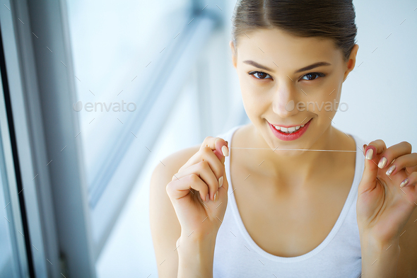 Dental Care. Woman With Beautiful Smile Using Floss For Teeth. High ...