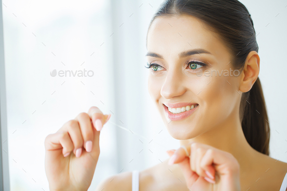 Dental Care. Woman With Beautiful Smile Using Floss For Teeth. High ...