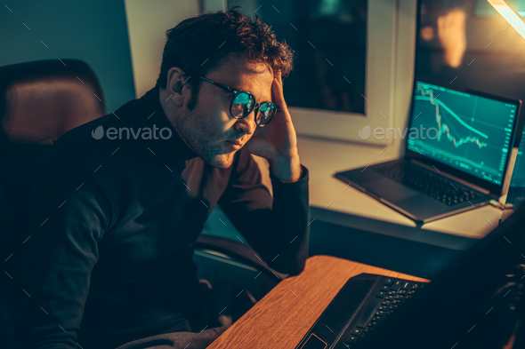 This portrait of a young adult man, working late into the night in his ...