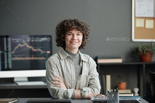 Young successful female financial analyst sitting by workplace Stock ...