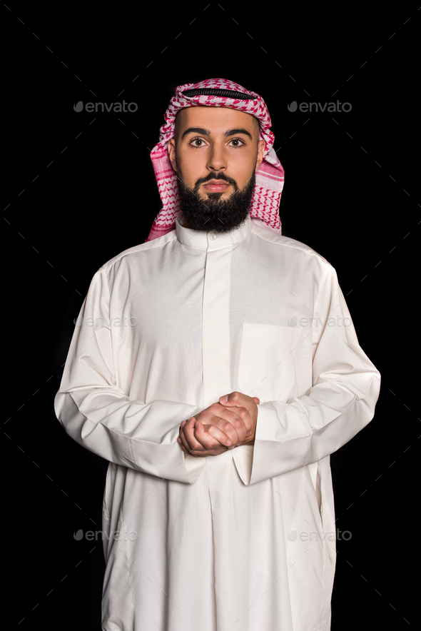 handsome man in traditional muslim clothing isolated on black Stock ...