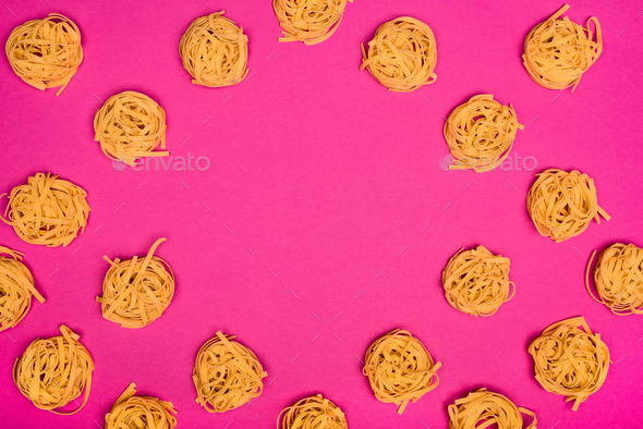flat lay round frame of raw pasta nests on pink Stock Photo by ...