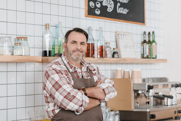 bartender with crossed arms leaning back on bar counter Stock Photo by ...