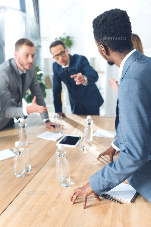 businesspeople having conversation at conference hall Stock Photo by ...