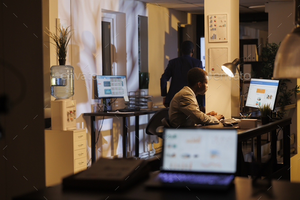 Advisor agent standing at desk table analyzing marketing statistics ...