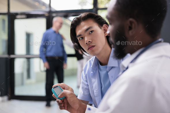 African american physician measuring insulin level and glucose in blood ...