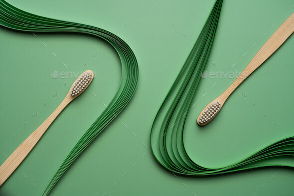 Bamboo toothbrushes on green background with quilling Stock Photo by ...