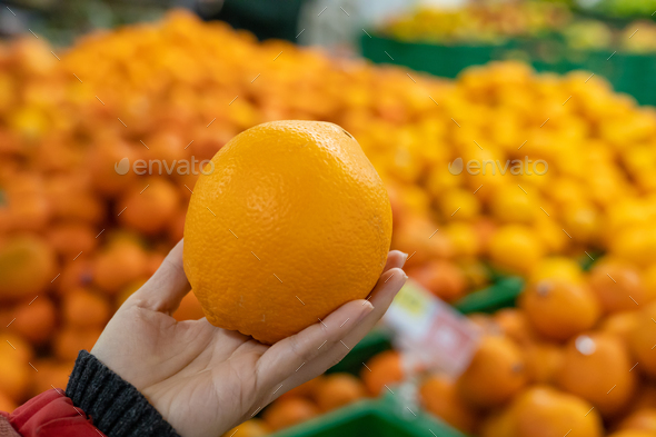 Pick orange, female hand pick up orange in supermarket. Stock Photo by ...