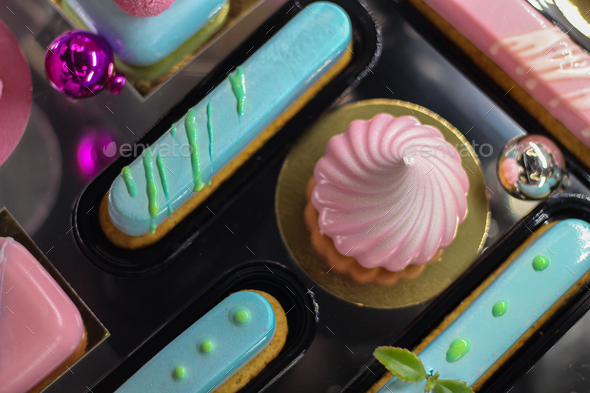 Mousse cakes and eclairs in a New Year's pastry shop window. Stock ...