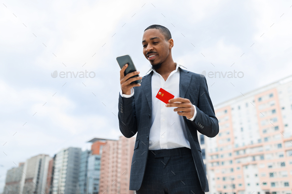Online Banking. Black Businessman Using Smartphone And Credit Card ...