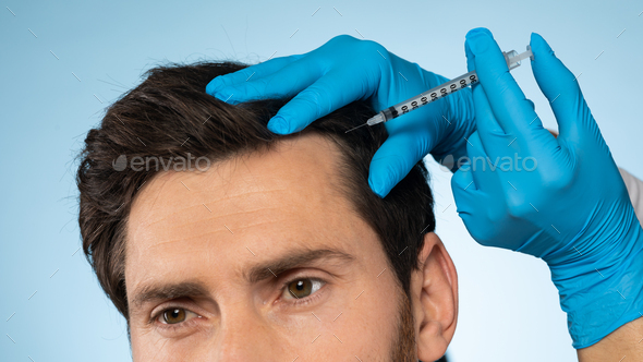 Handsome man receiving injections in his head, having mesotherapy ...