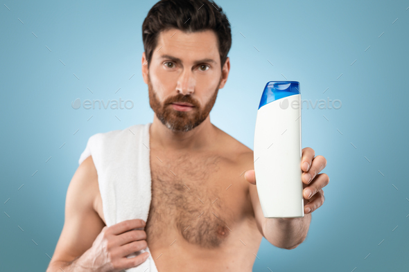 Cosmetics product ads template. Shirtless man holding tube of shampoo ...