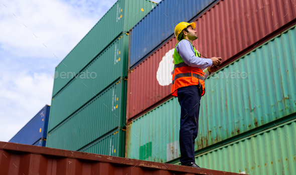 Warehouse engineer working at container yard Stock Photo by 1footage