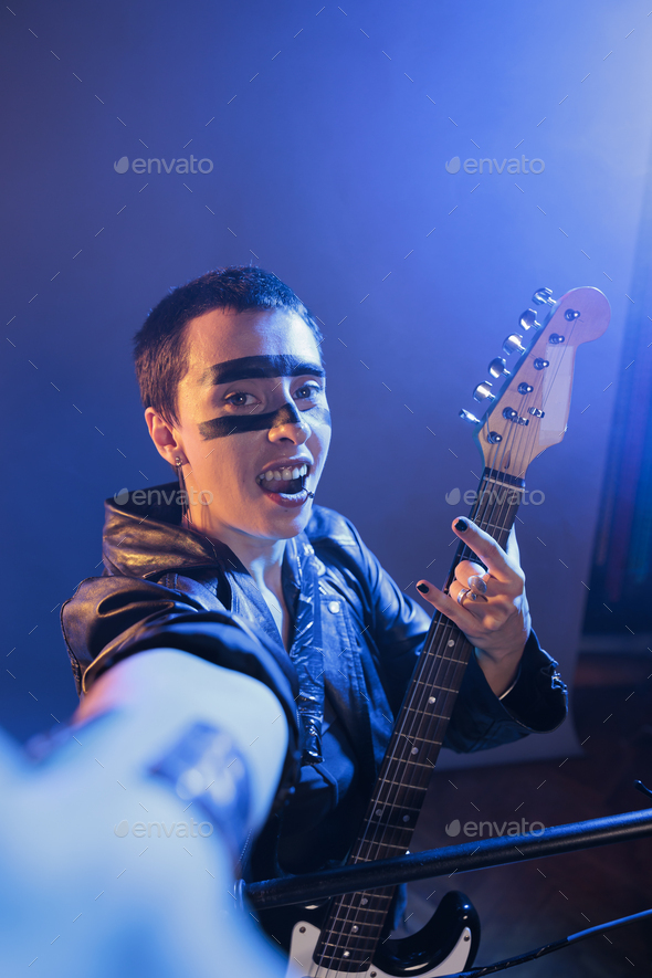 Punk rocker showing rock sign on camera Stock Photo by DC_Studio ...