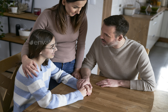 Caucasian parents talking with teenager girl and sitting around the ...