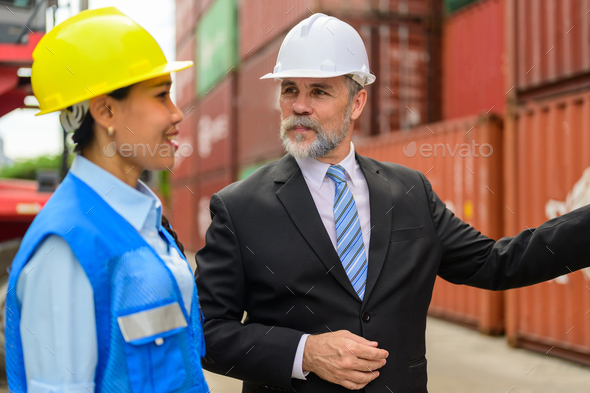 Warehouse engineer working at container yard Stock Photo by 1footage