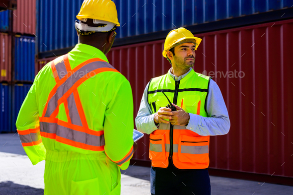 Warehouse engineer working at container yard Stock Photo by 1footage