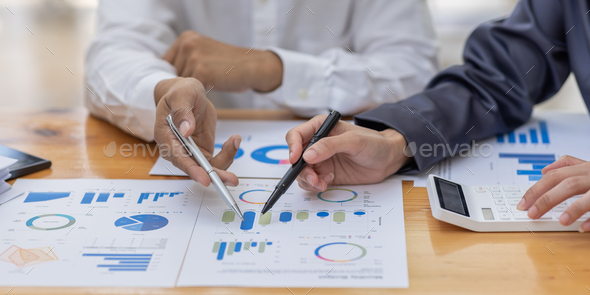 Two Asian business colleagues working together on new project in ...