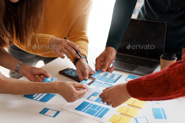 Designer, programmers, developers of mobile applications work together to invent a modern mobile ...