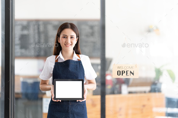 Portrait of a Bright smiling woman prepares to open a shop to welcome ...
